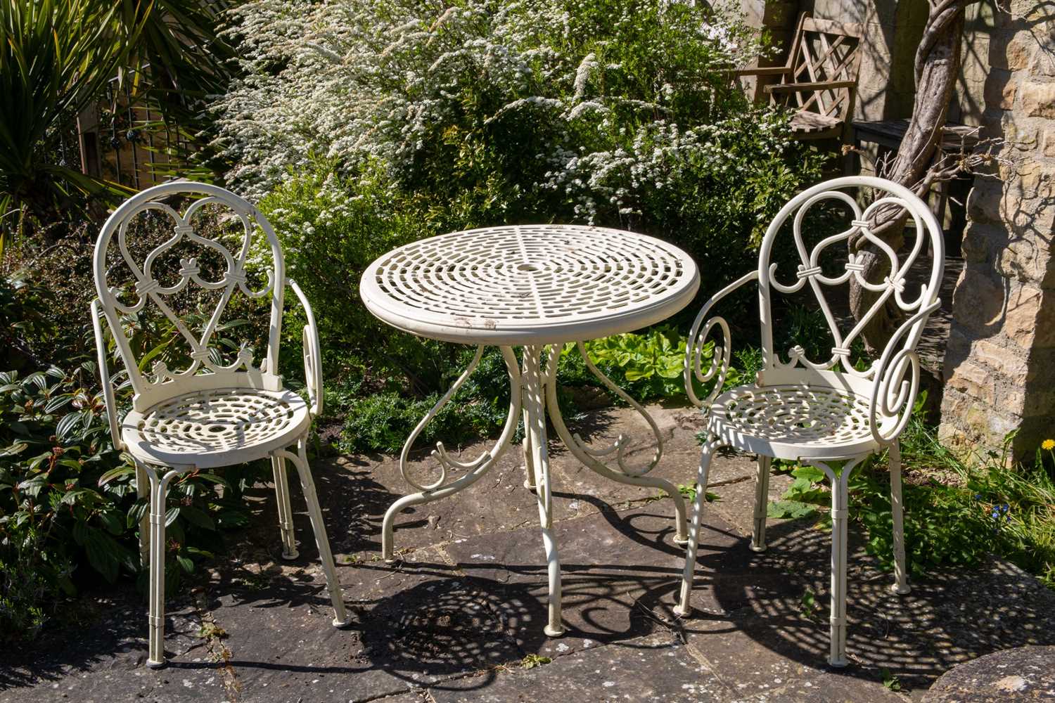 Lot 741 - A white painted cast aluminium table and two